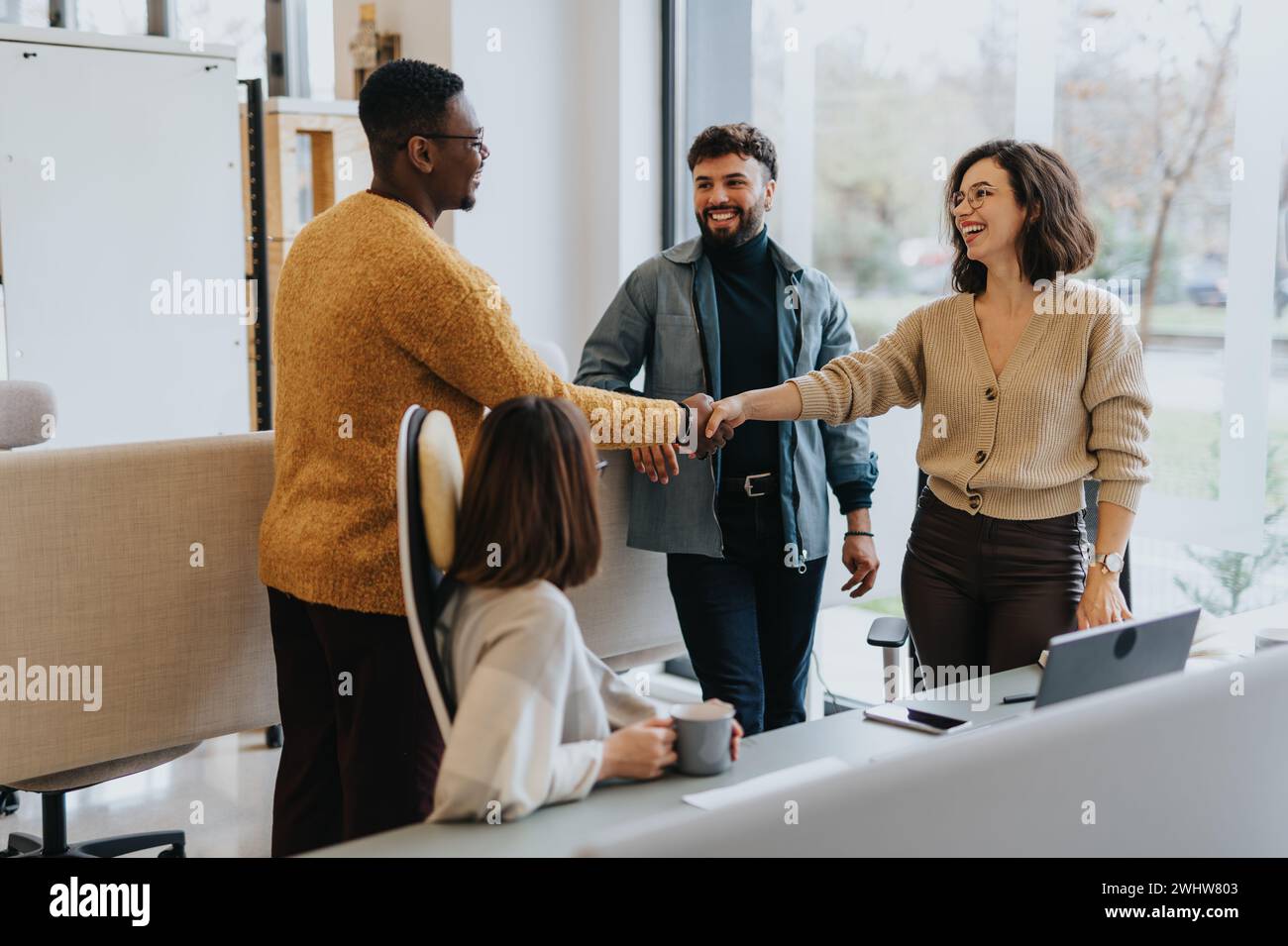 The woman warmly welcomes her new colleague, extending a friendly ...