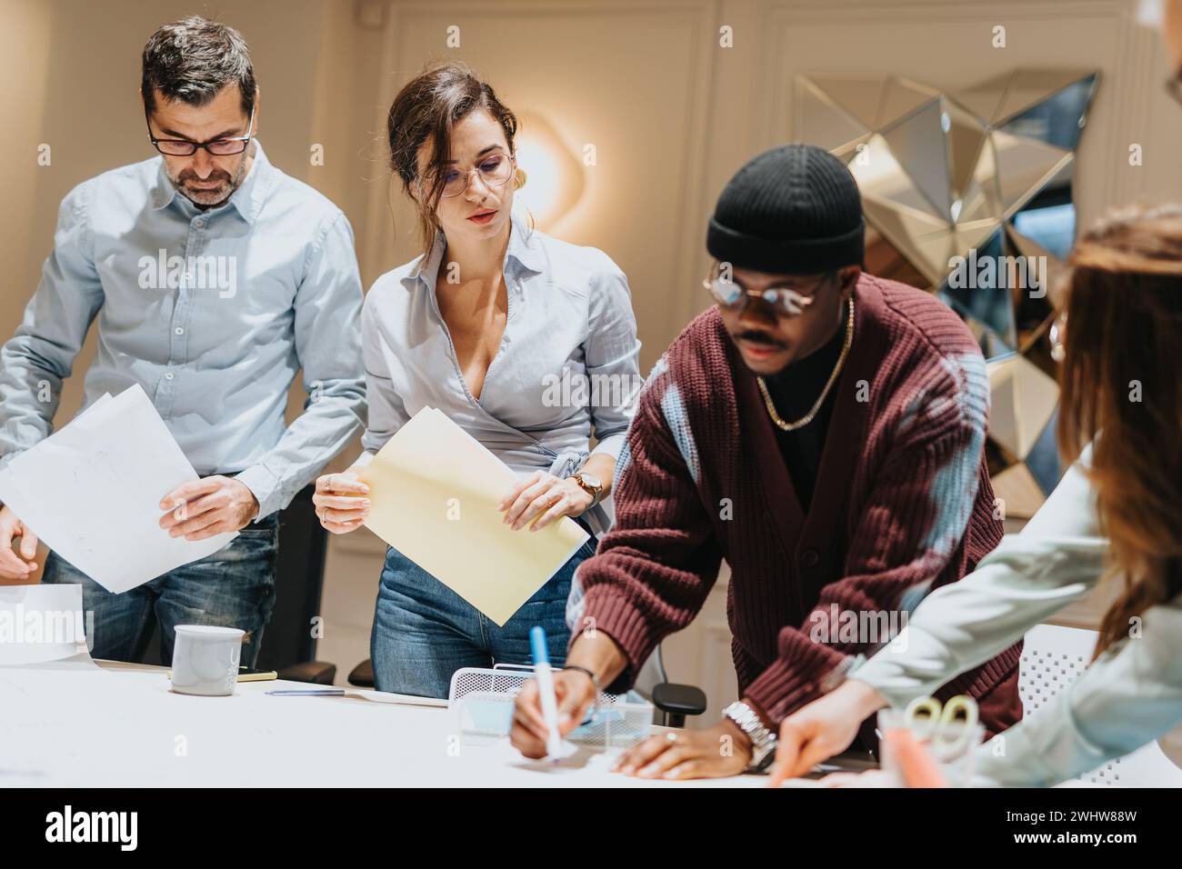 Multi generational team of businesspeople collaborating and innovating ...