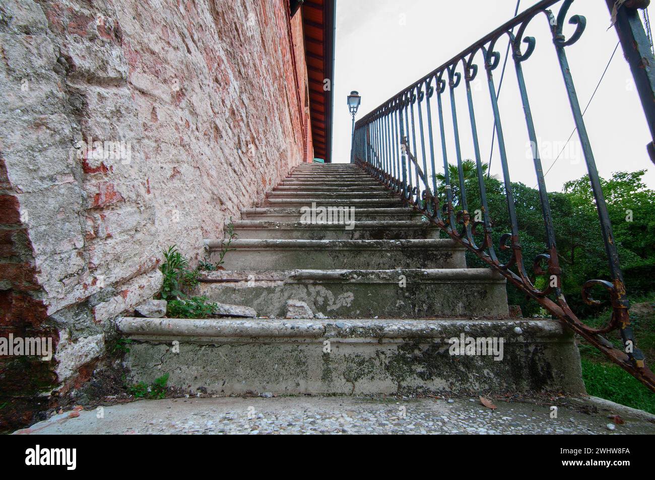 Stone stairs with metal railing seen from below Stock Photo - Alamy