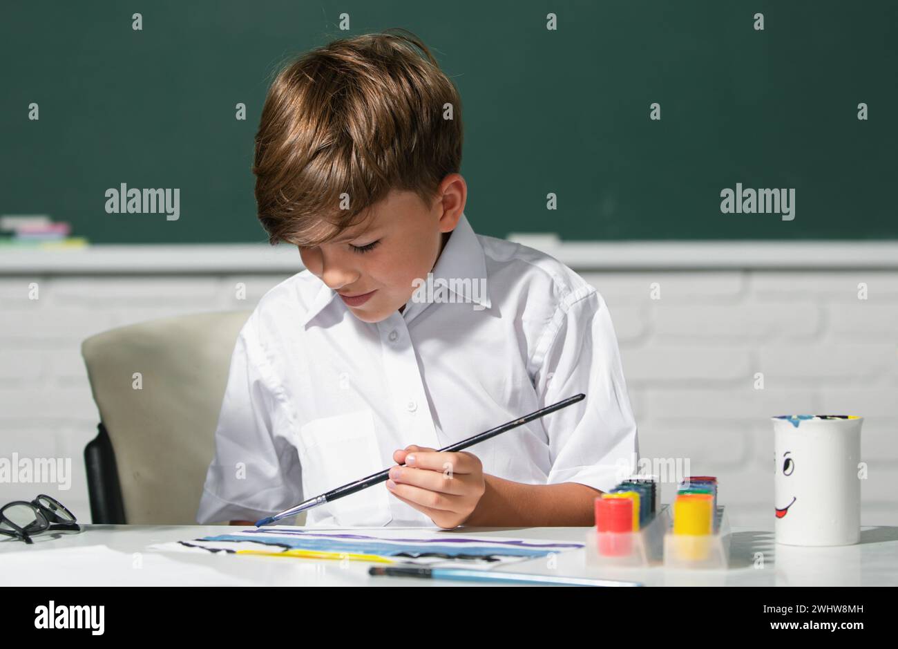 Child boy drawing with coloring pens, painting with early development ...