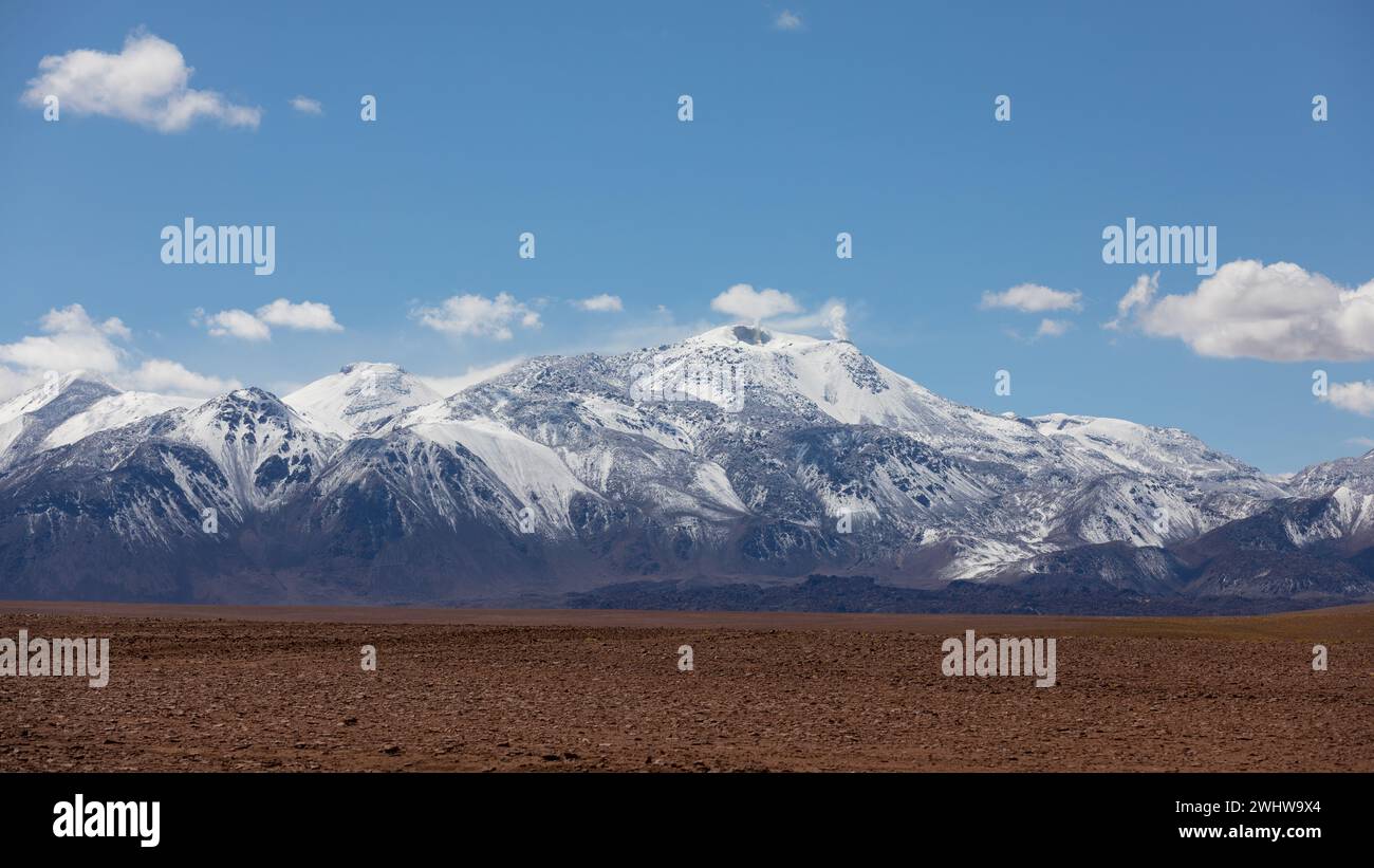 Snow-covered volcano with volcanic funnel in the Atacama Desert Chile ...