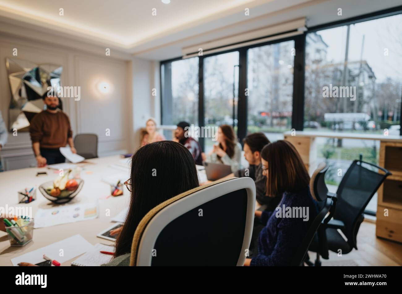 Multiethnic business team engaged in active discussion at modern office ...