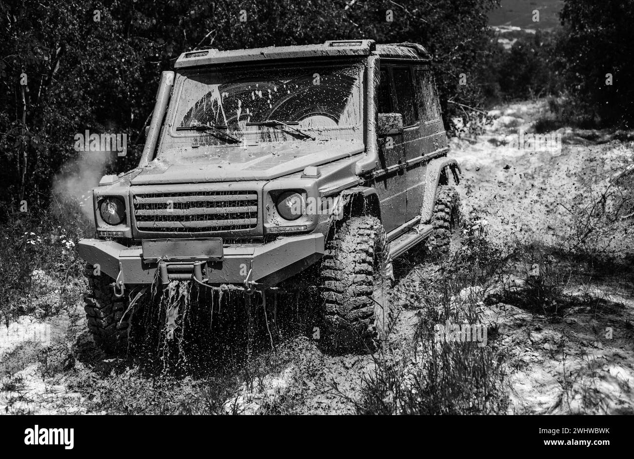 Travel concept with big 4x4 car. Offroad vehicle coming out of a mud ...