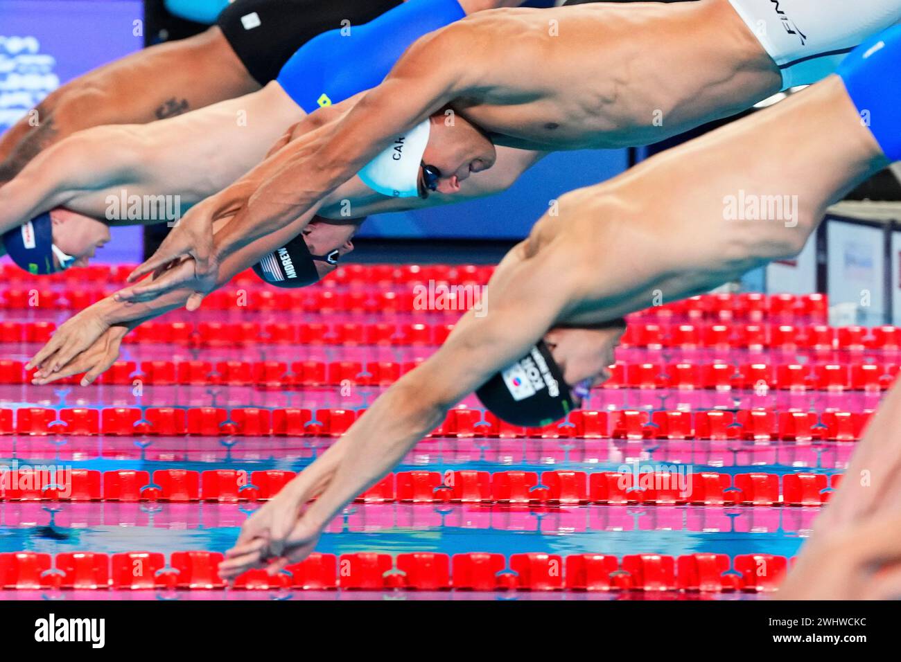 Dylan Carter of Trinidad and Tobago, centre, starts in a men's 50-meter ...