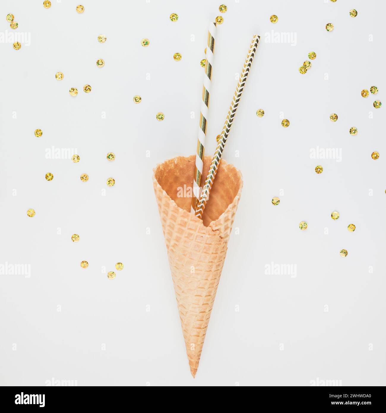 Golden party straws in waffle cone Stock Photo - Alamy