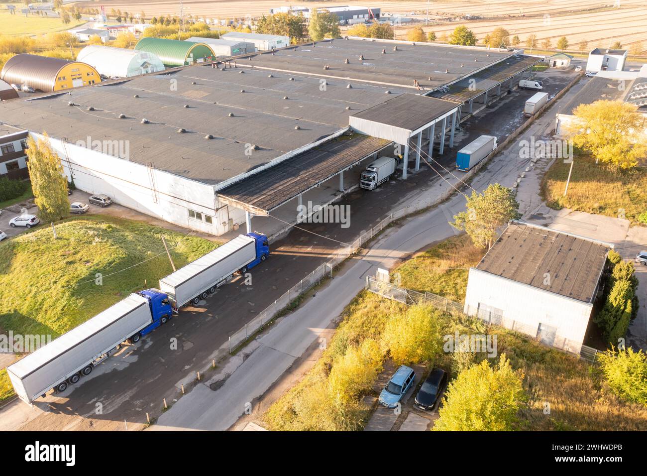 Drone photography of large warehouse complex with parked lorry's during ...