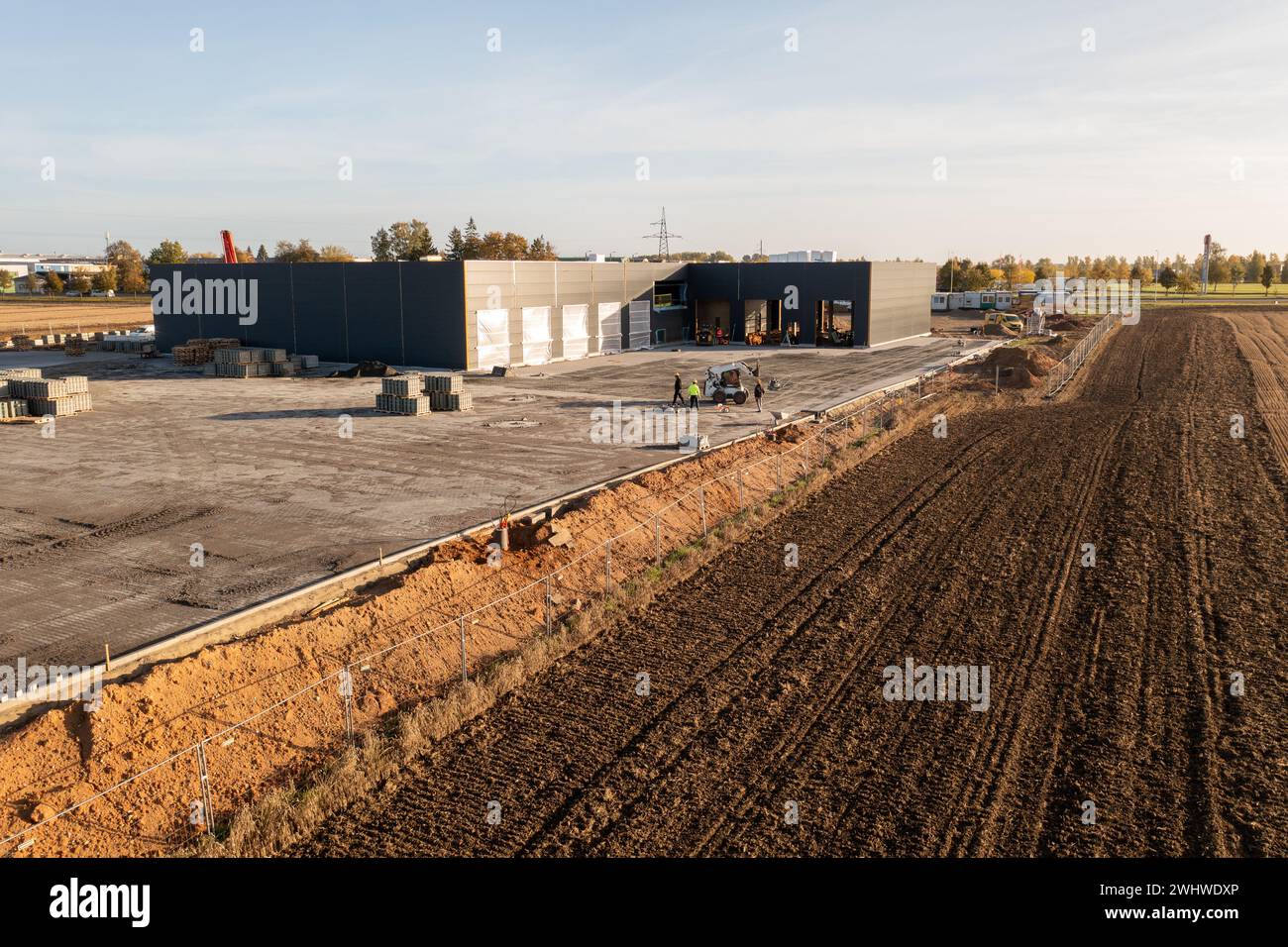 Drone photography of warehouse construction site in the fields during ...
