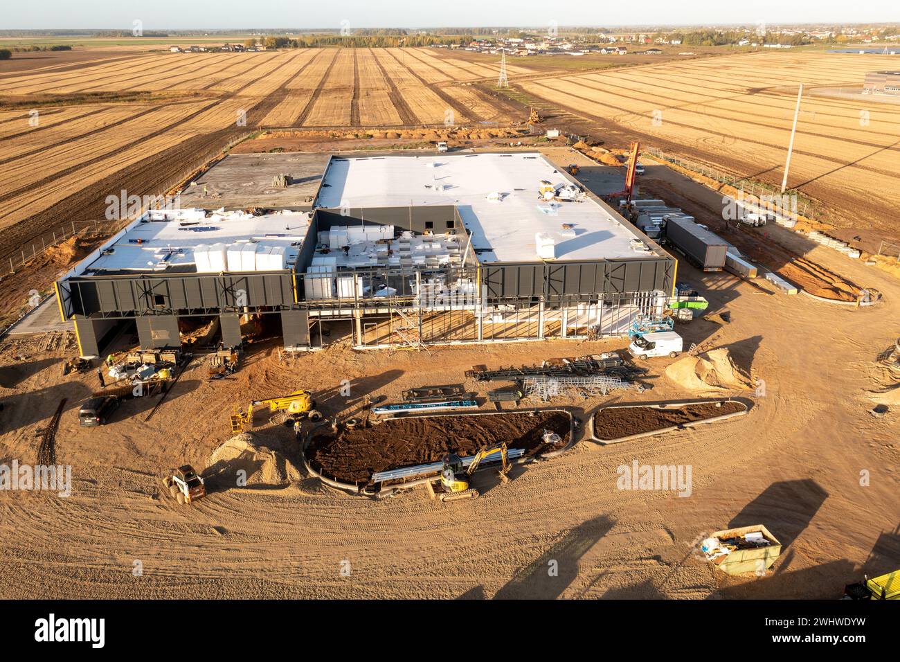 Drone photography of warehouse construction site in the fields during ...