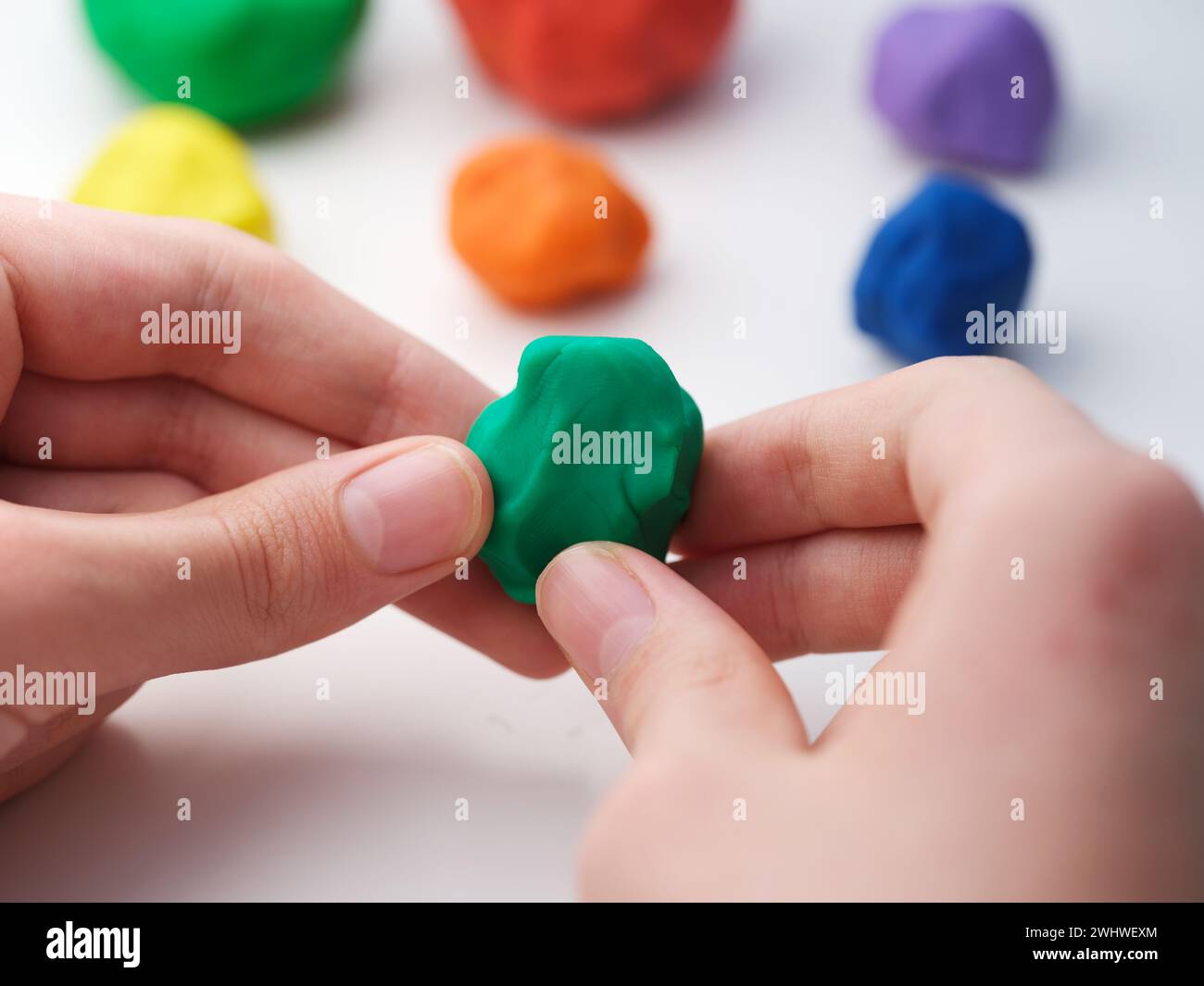 A young boy playing with play clay. Close up Stock Photo - Alamy