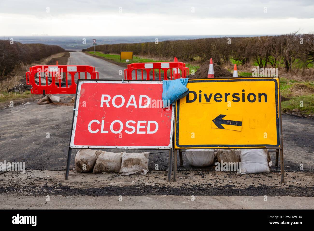 Road Closed and Diversion Signs with red barriers and traffic cones on ...