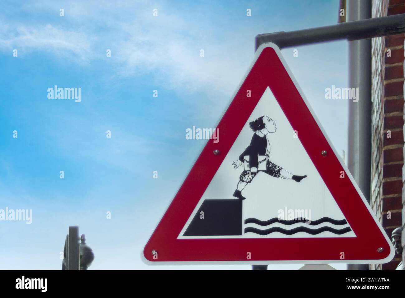 Sign warning about the danger of slipping into the water Stock Photo ...