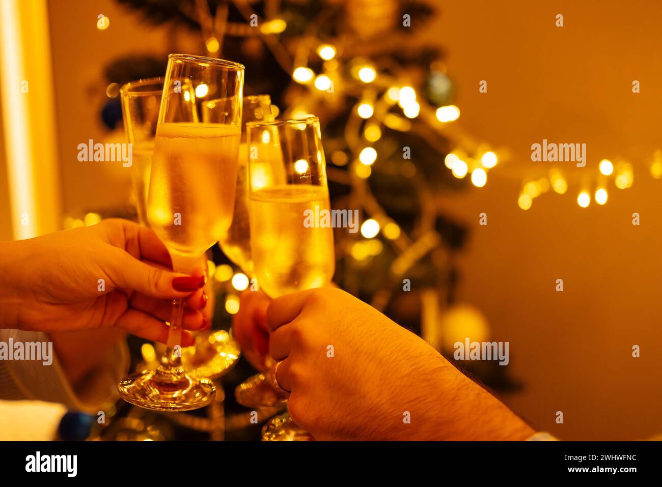 Female And Male Hands Holding Glasses With Champagne And Clicking Them