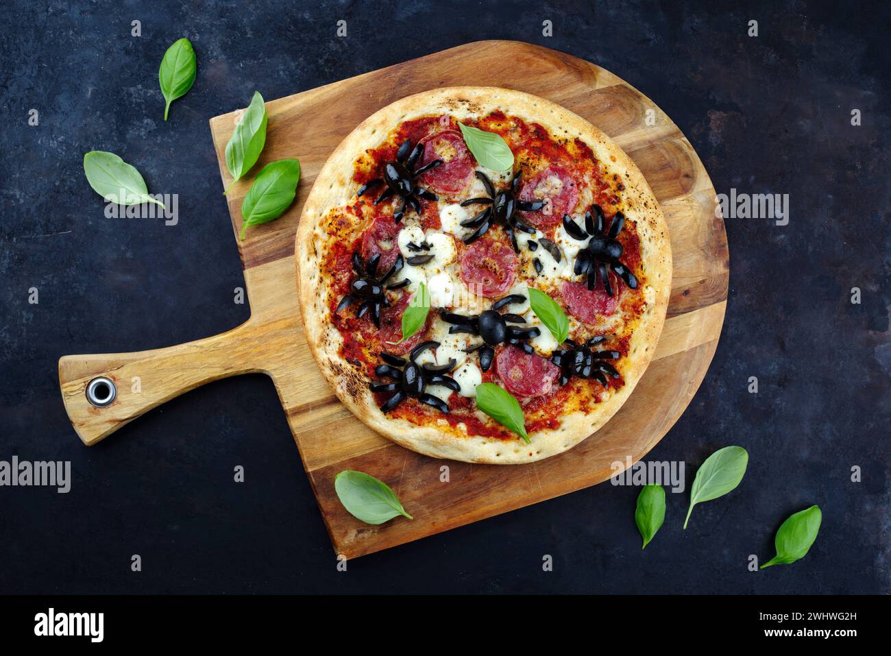 Traditional Italian Halloween spider pizza with salami Stock Photo - Alamy