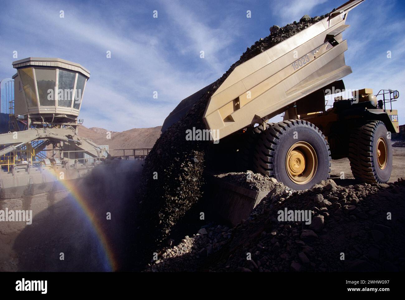 Truck dumps load of ore at El Abra Copper Mine; rainbow; Calama ...