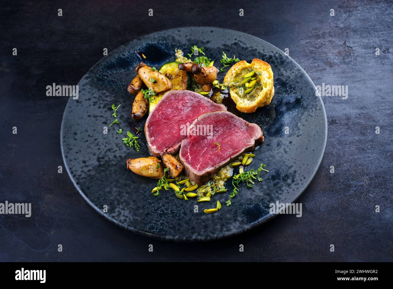 Fried Italian chianina beef fillet steak very rare with mushrooms Stock ...
