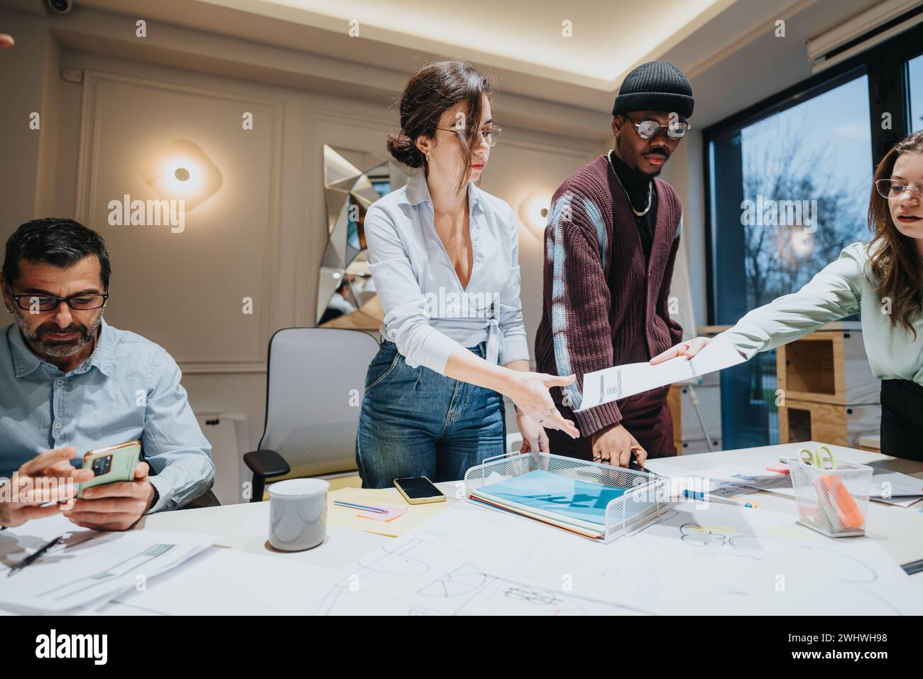 Multigenerational business colleagues engage in a collaborative meeting ...