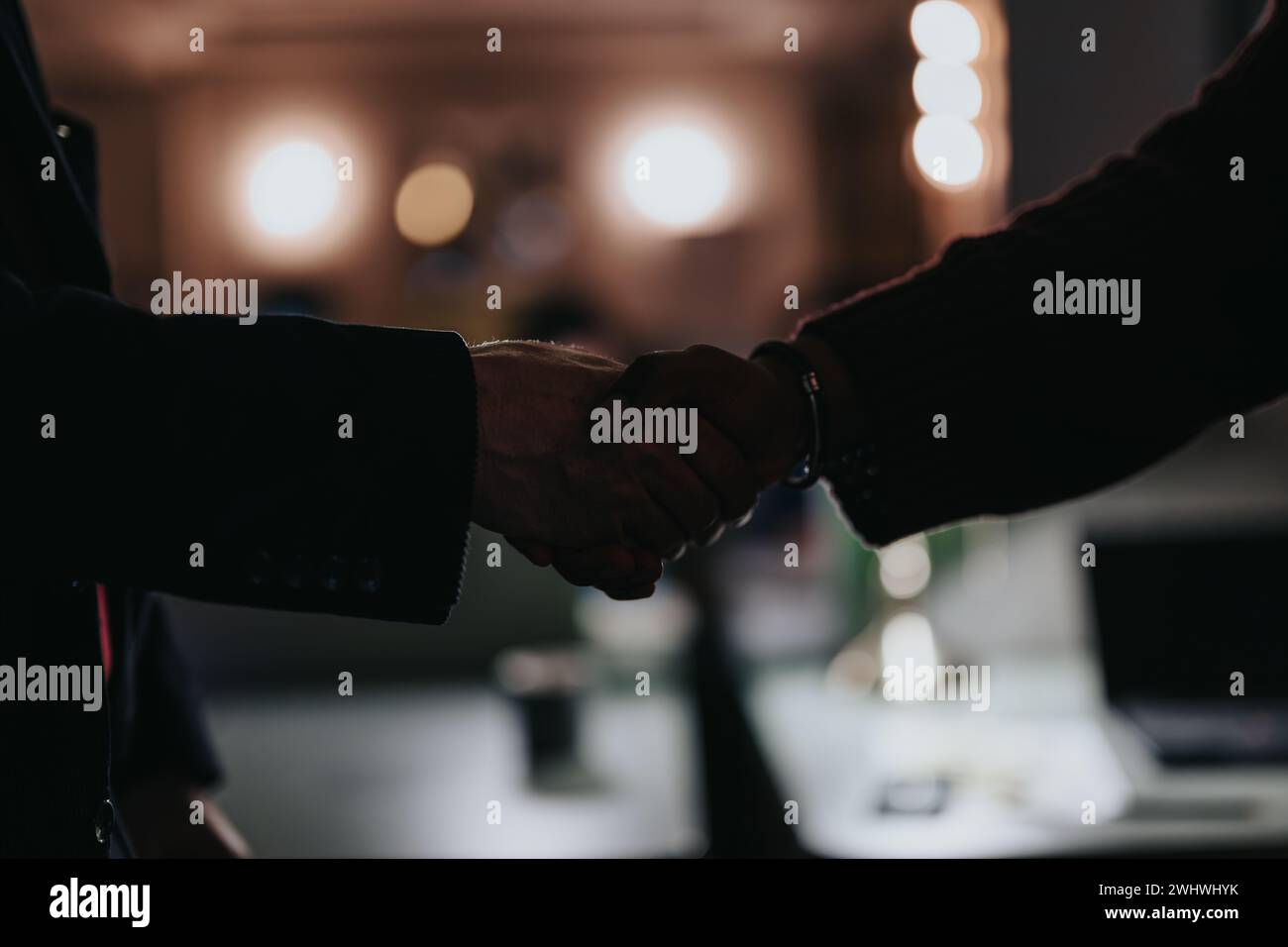 Business partners shaking hands at multigenerational meeting, corporate ...