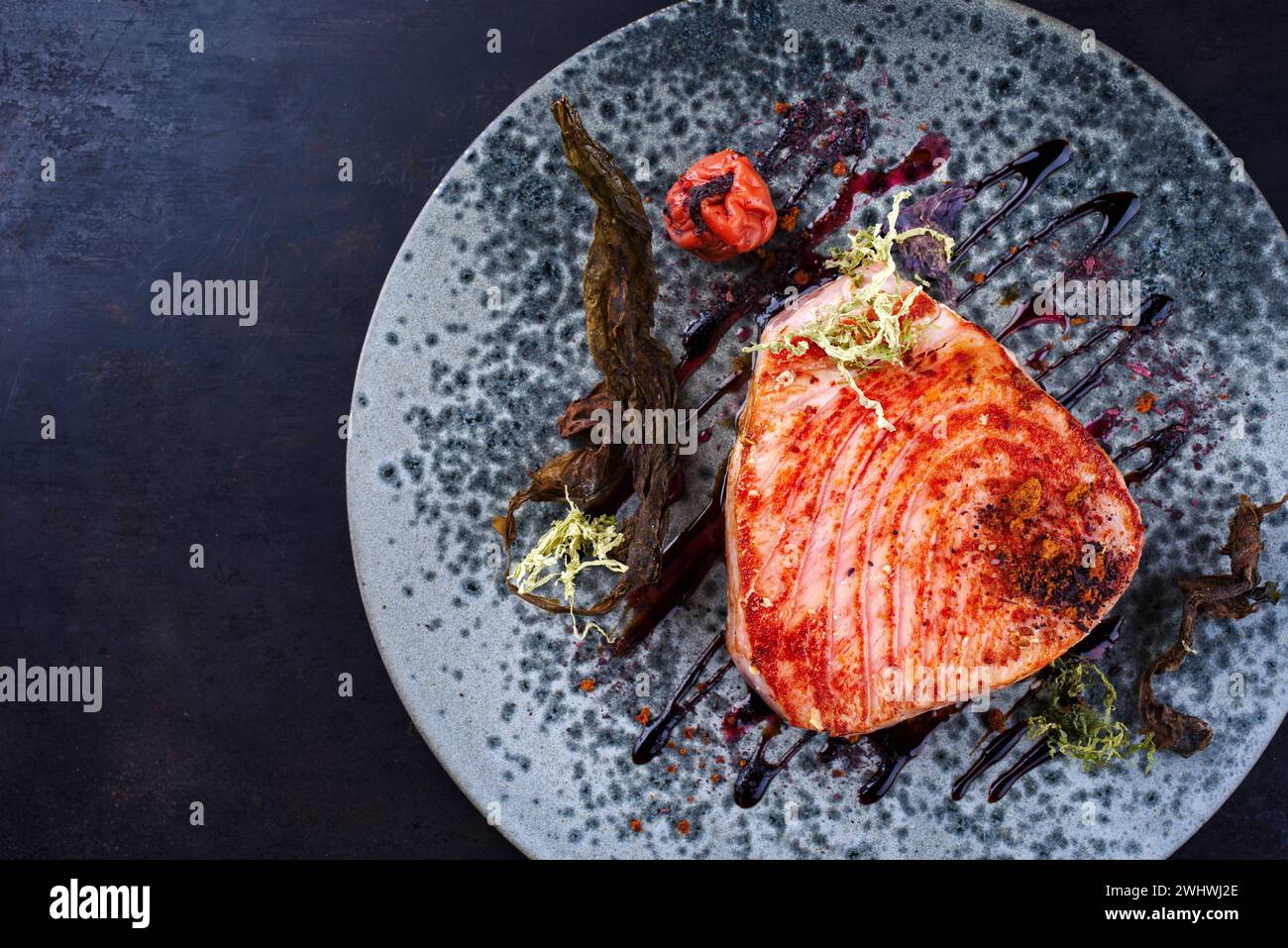 Traditional Japanese gourmet tuna fish steak tataki with algae and ...