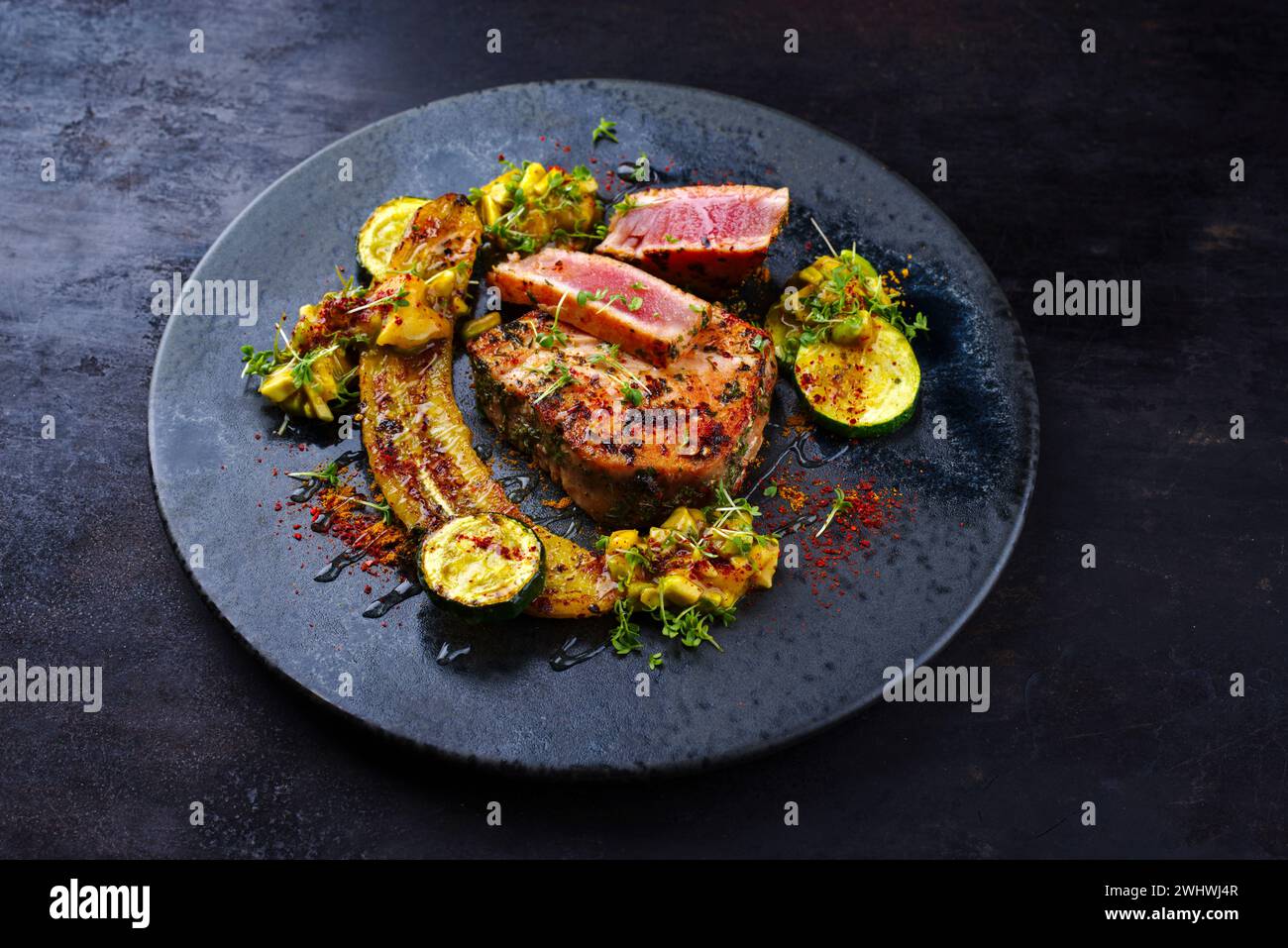 Fried gourmet tuna fish steak with banana Stock Photo - Alamy