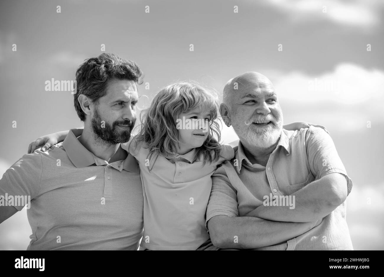 Three generations of men together, portrait of smiling boy, dad and ...