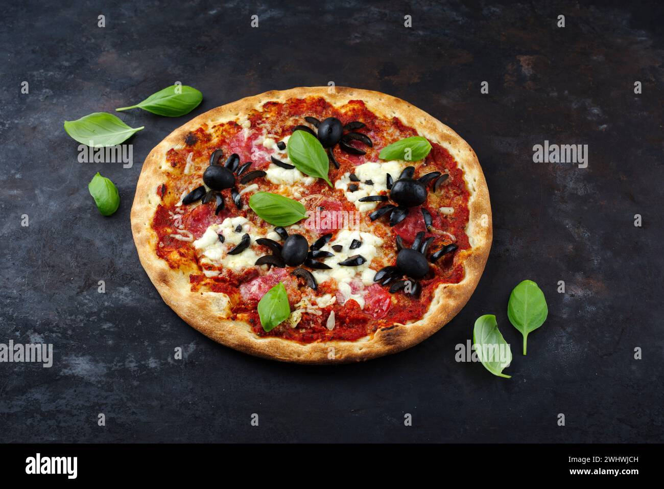 Traditional Italian Halloween spider pizza with salami Stock Photo - Alamy