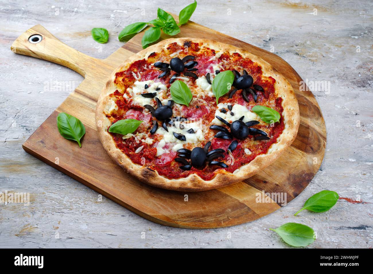 Traditional Italian Halloween spider pizza with salami Stock Photo - Alamy