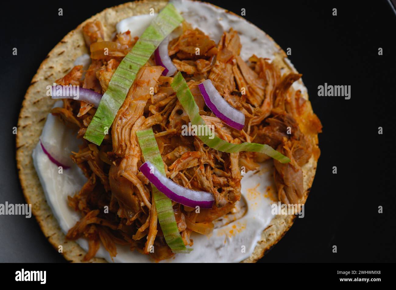 Tostada with Mexican Chicken Tinga, Tinga de Pollo Stock Photo - Alamy