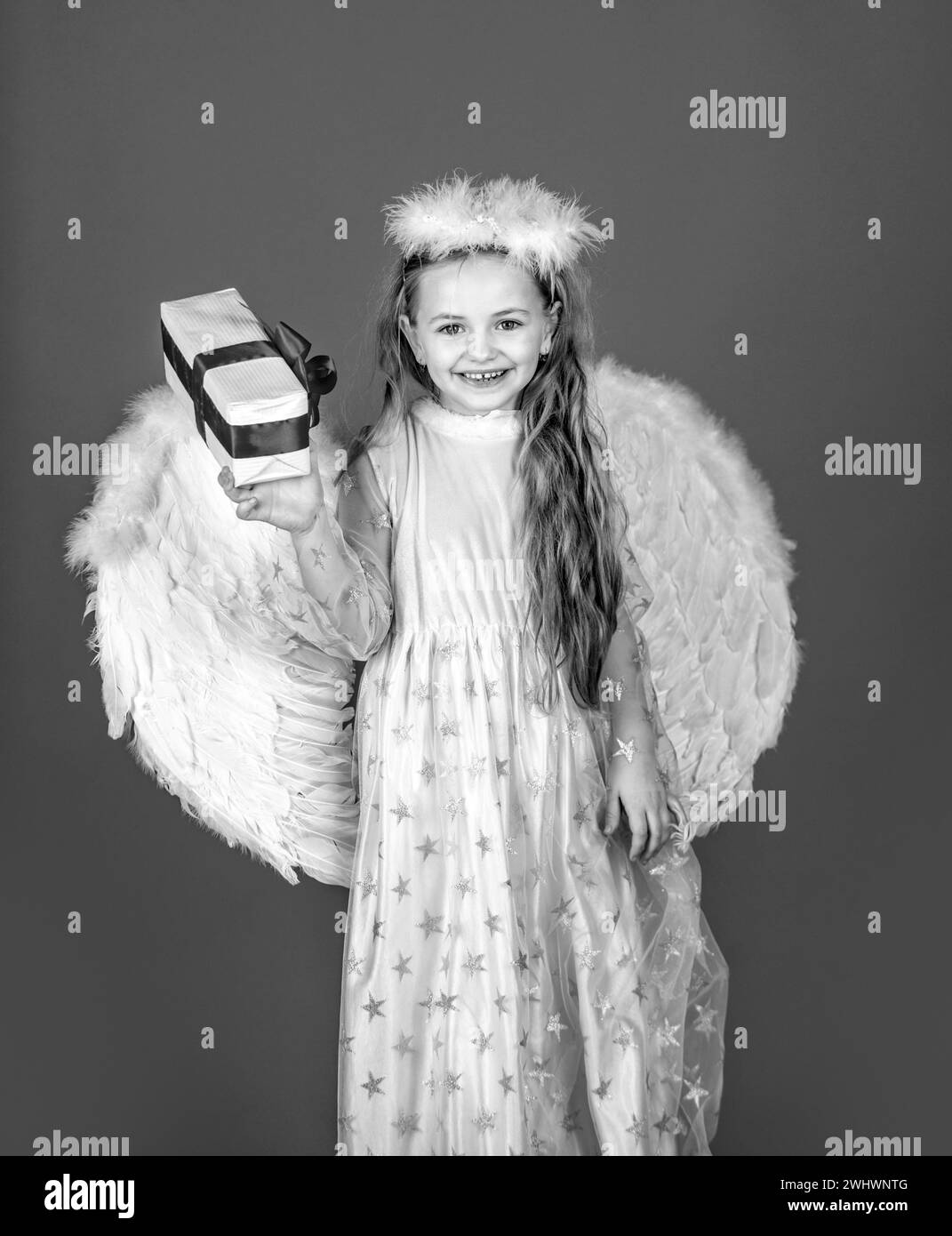 Cute angel happy smiling child girl with angels wings, isolated on red ...