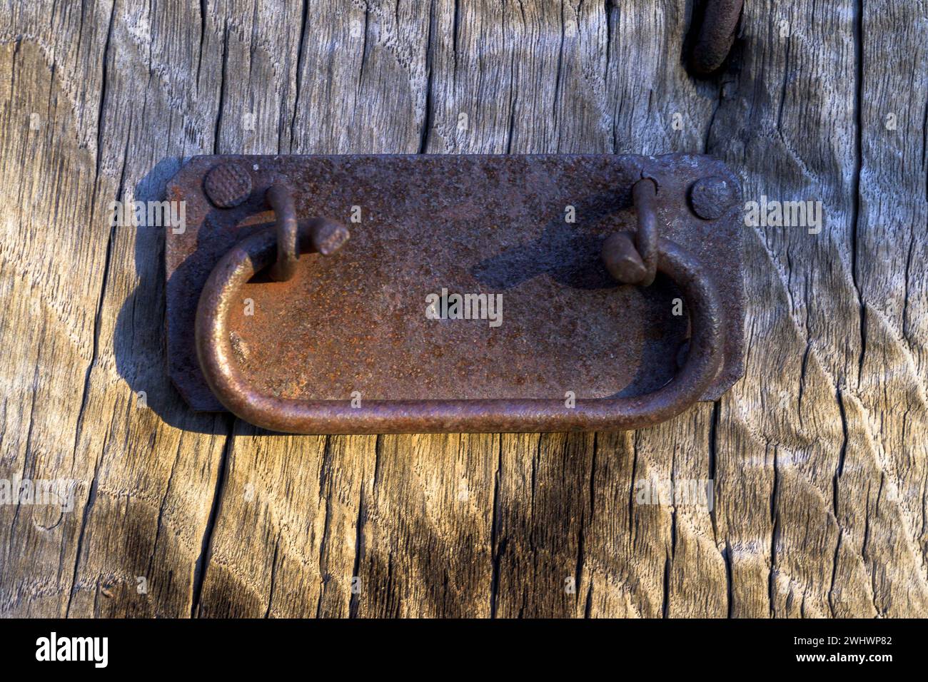 Rusty old door handle handle on old wooden door in vertical Stock Photo ...