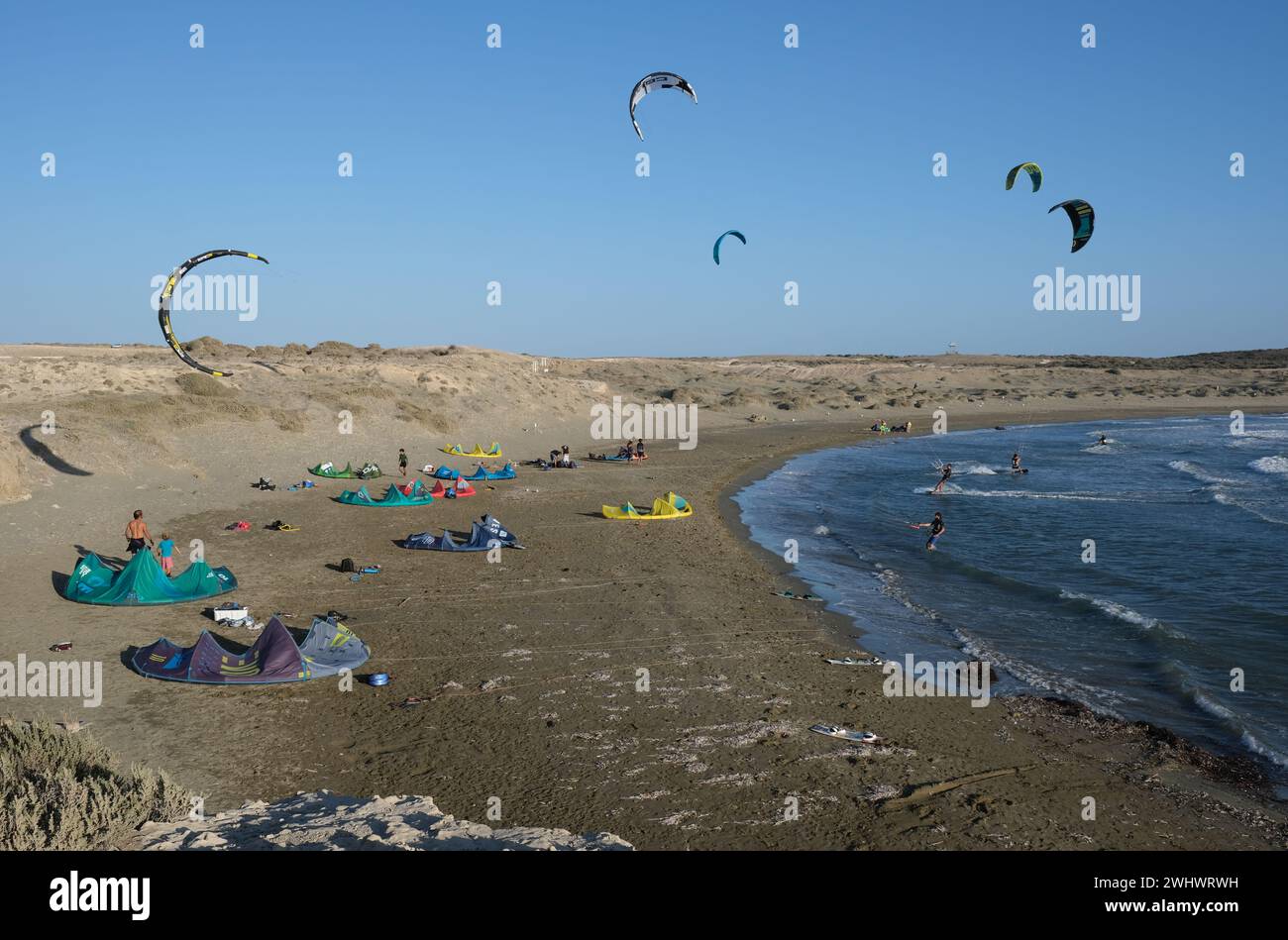 Group of Kite surfers doing kite surfing on a sunny day with clear blue ...