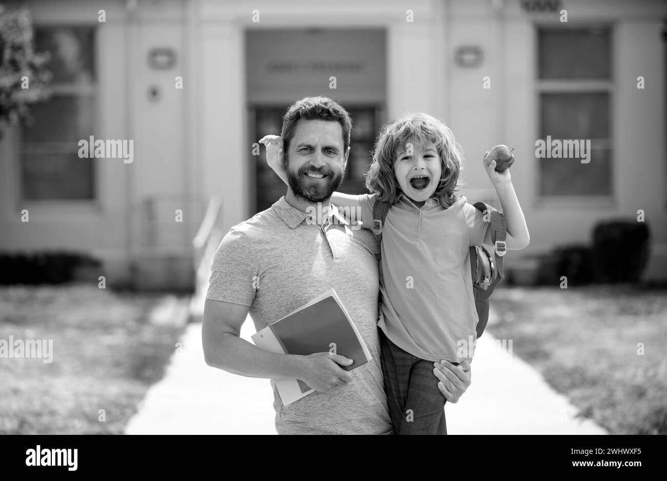 Portrait of teacher and happy pupil. Father supports and motivates son ...