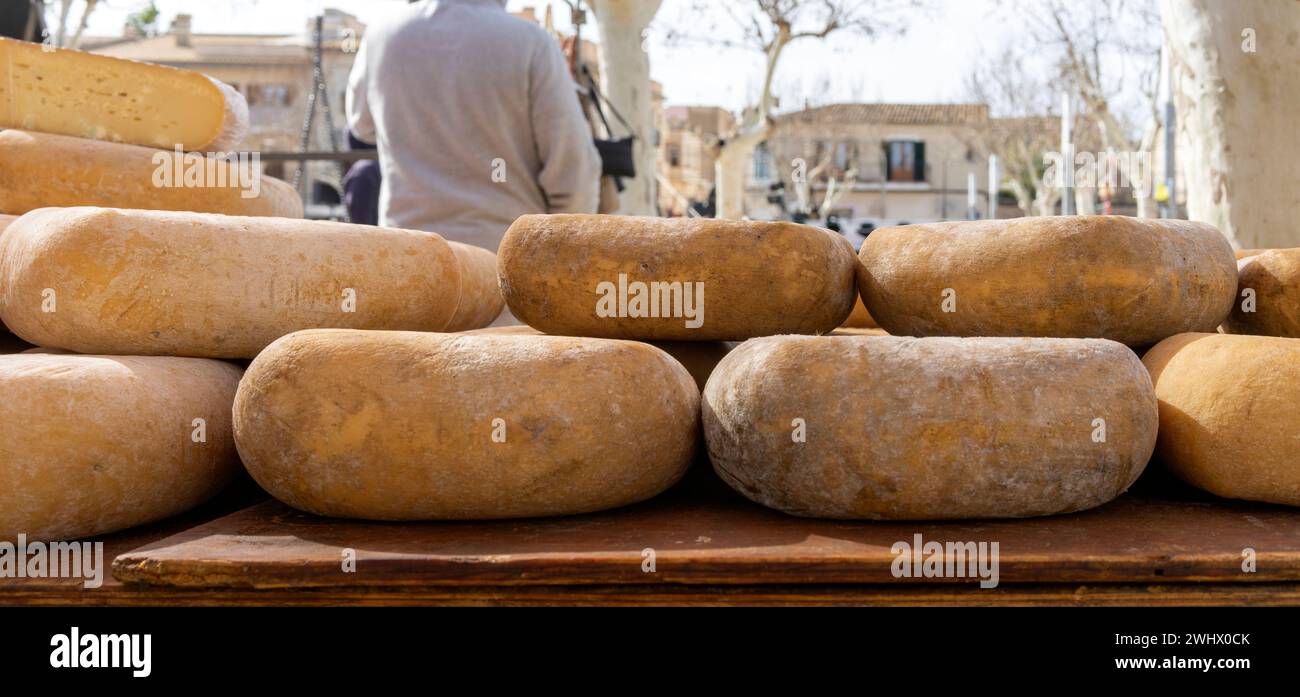 Artisanal Cheese Wheels Stacked at a Rustic Market Stall Stock Photo ...