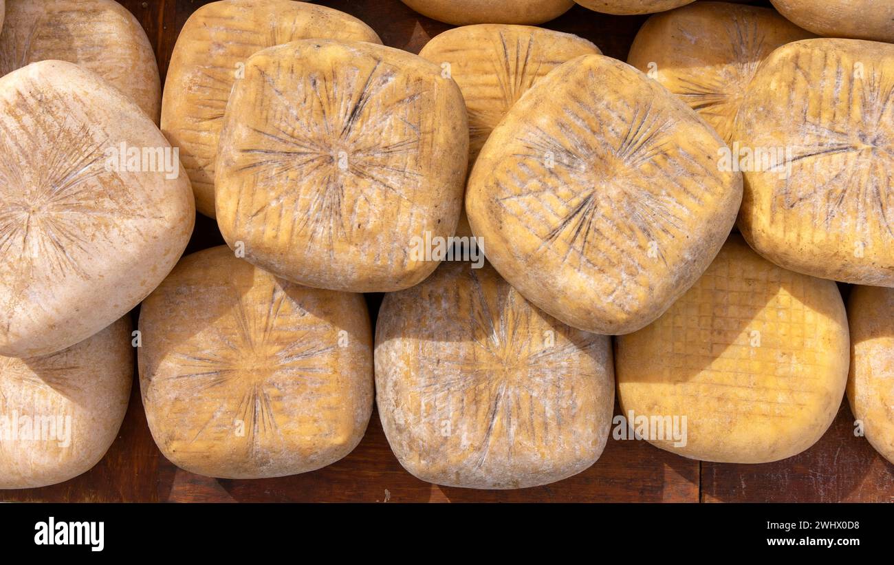 Artisanal Cheese Wheels Stacked at a Rustic Market Stall Stock Photo ...