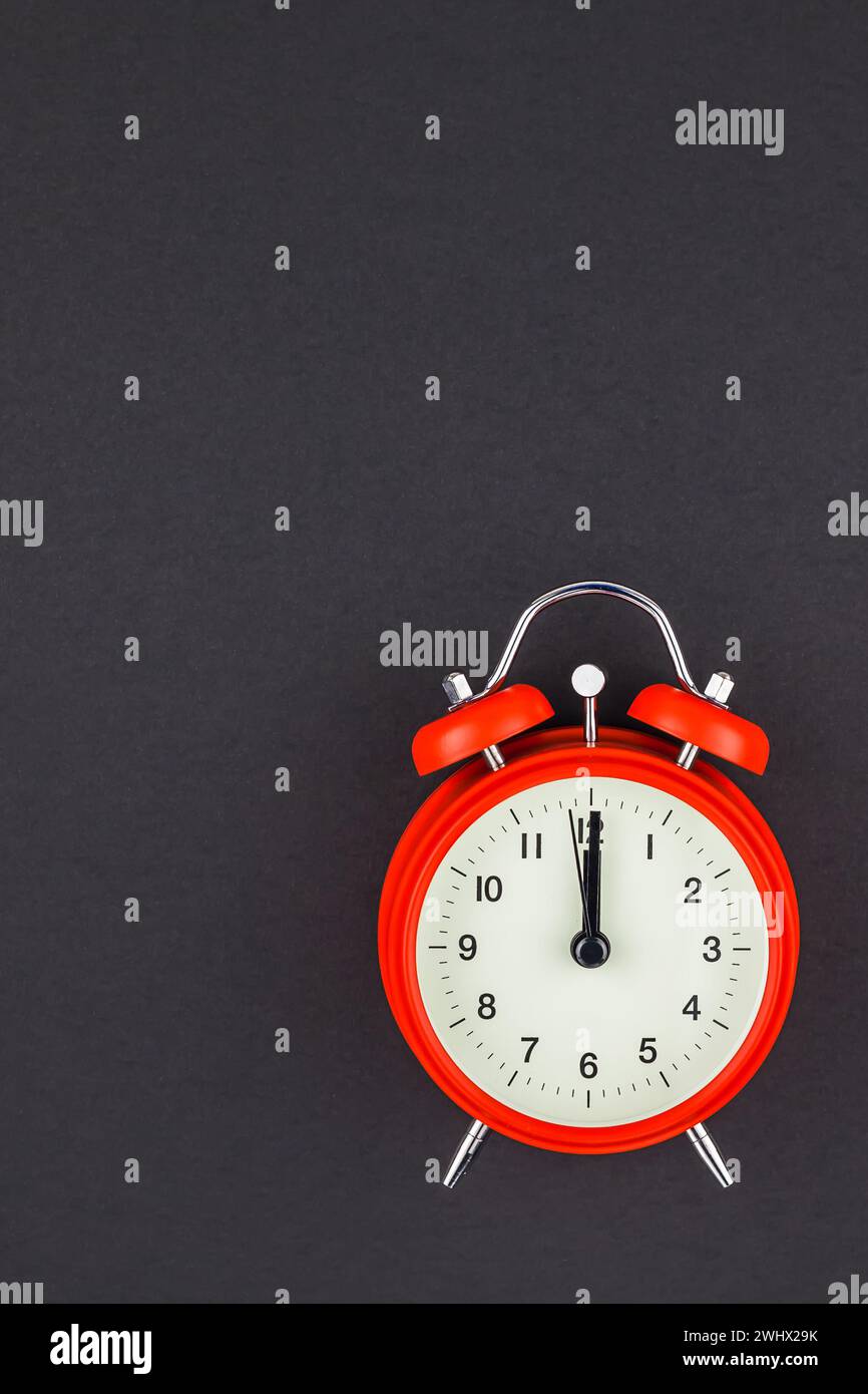Red vintage alarm clock on dark background Stock Photo - Alamy