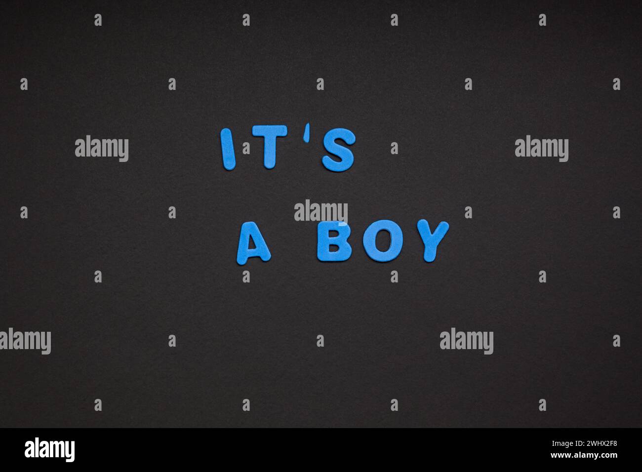 Creative blue text made from plastic letters It's a boy writing on ...