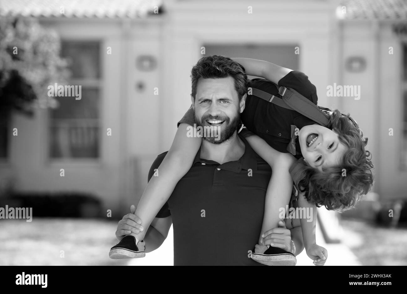 Father giving son piggyback ride after come back from school. School ...