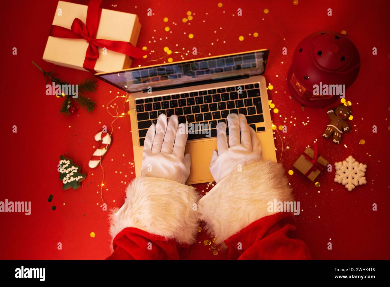 Santa Claus with laptop. Hands in white gloves typing on an notebook ...