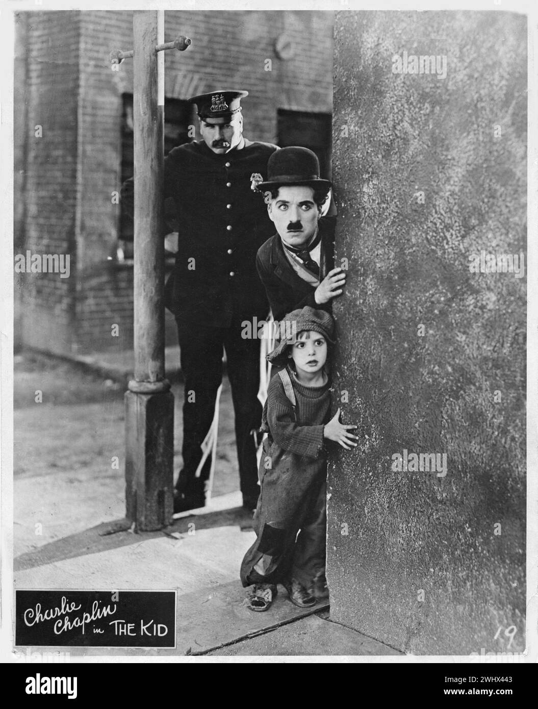 CHARLES CHAPLIN, child actor JACKIE COOGAN and TOM WILSON in a scene ...