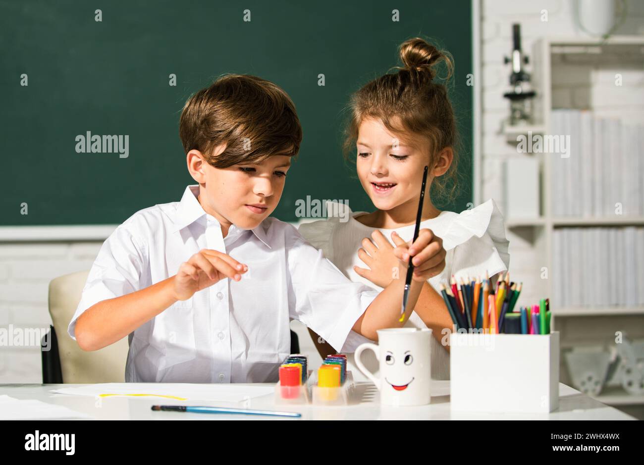 Children brother and sister drawing cute draw using colored pencils at ...