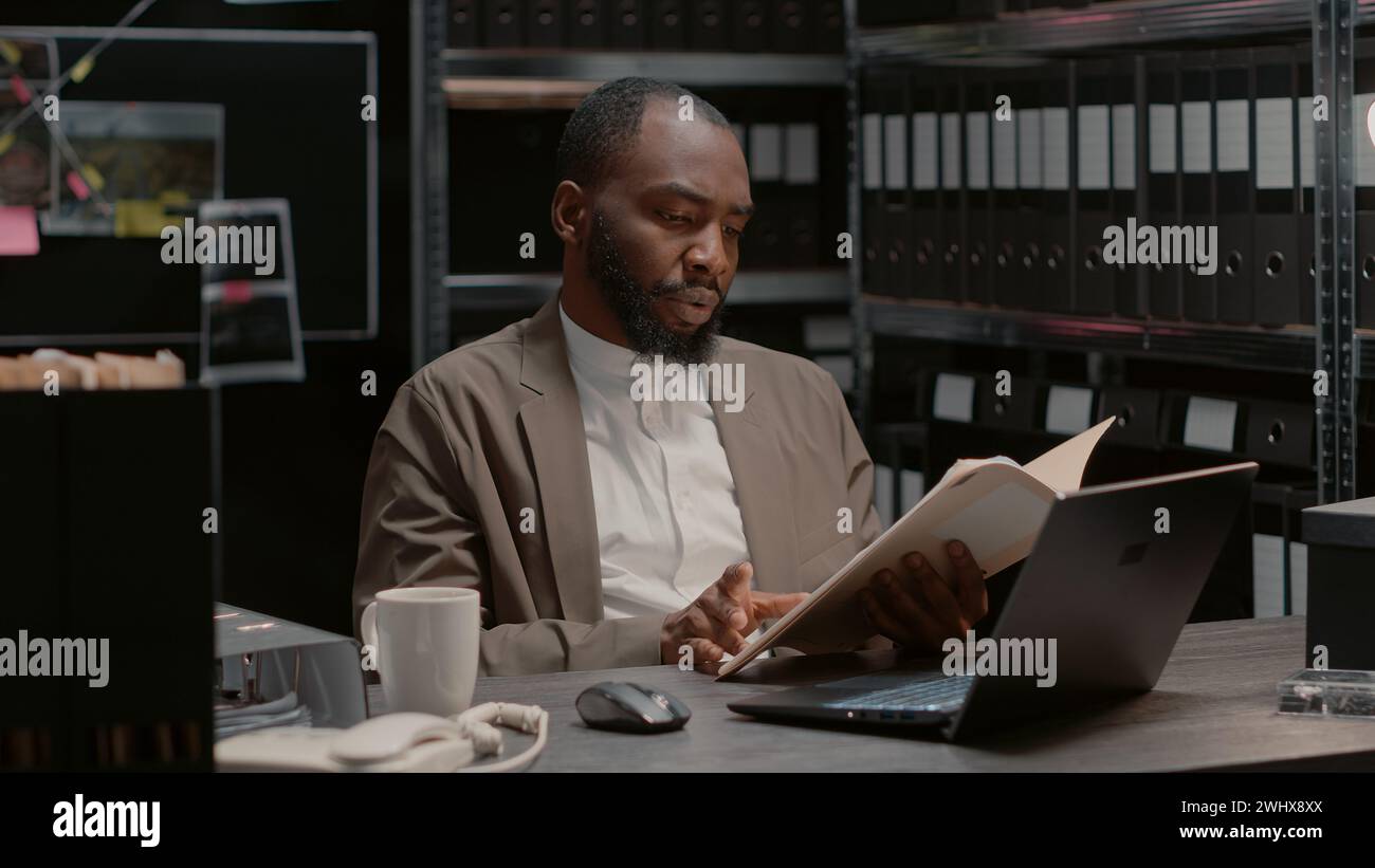 Male inspector reading case files hi-res stock photography and images ...