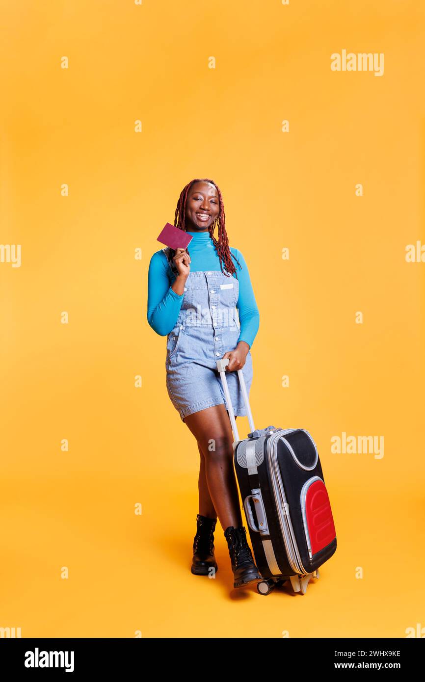 Joyful traveller with passport leaving on international getaway ...