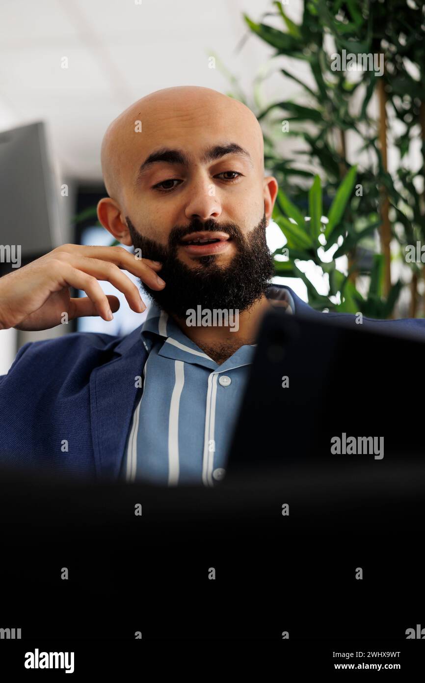 Arabian businessman having video call with coworker about startup ...