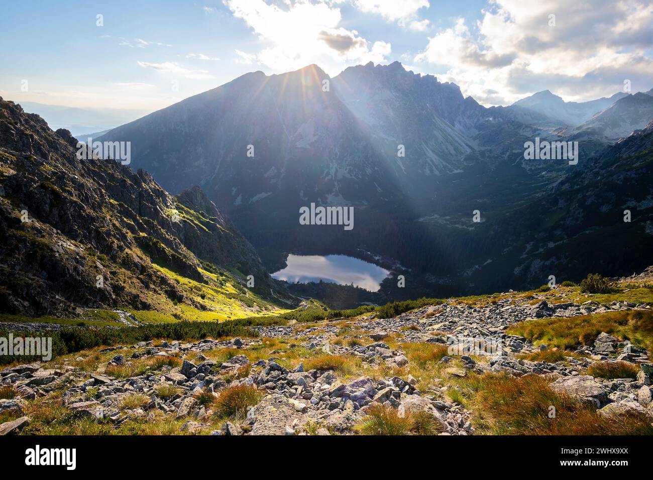 Sunshine over mountain lake Stock Photo - Alamy