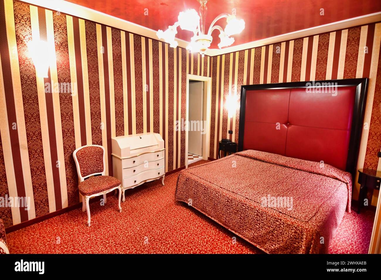 Interior of an old vintage red hotel room in the italian old city of ...
