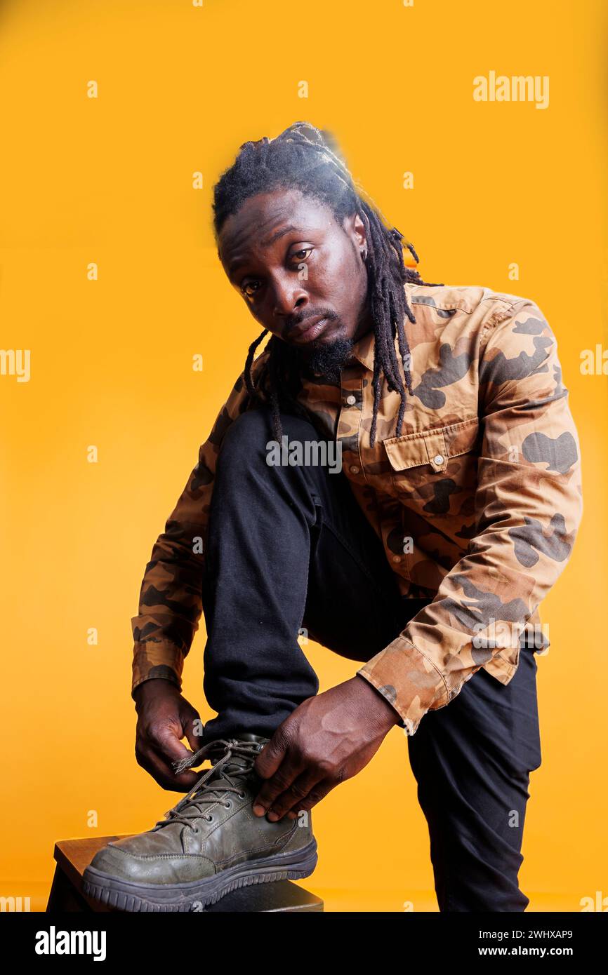 African man tying sneaker hi-res stock photography and images - Alamy