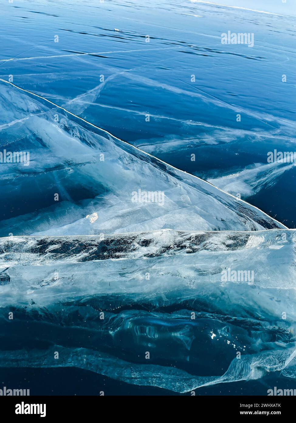 Texture of beautiful blue ice with cracks and air bubbles in the frozen ...