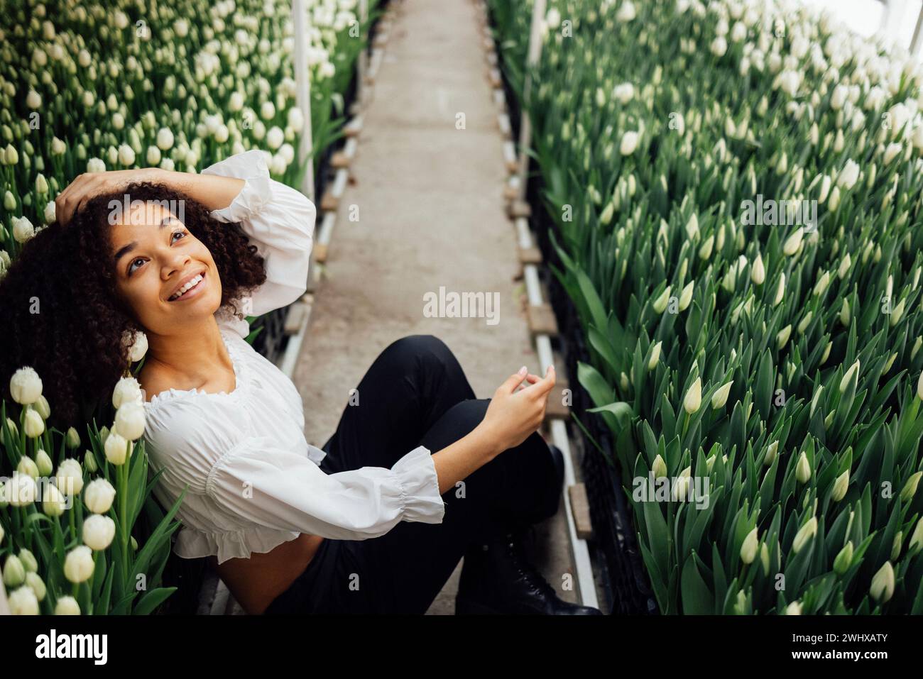 Female Portrait Of Attractive Darkskinned Girl Sitting On Path Among
