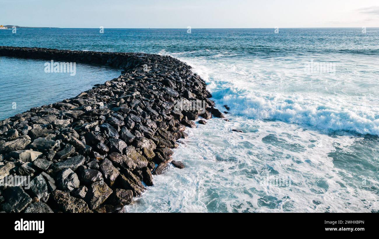 Aerial view of a seawall with clear turquoise water Stock Photo - Alamy