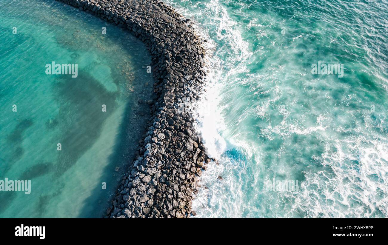 Aerial view of a seawall with clear turquoise water Stock Photo - Alamy