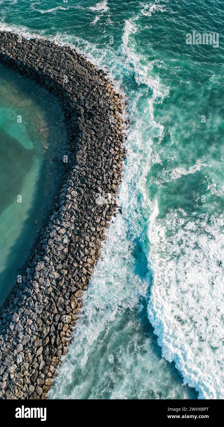 Aerial view of a seawall with clear turquoise water Stock Photo - Alamy